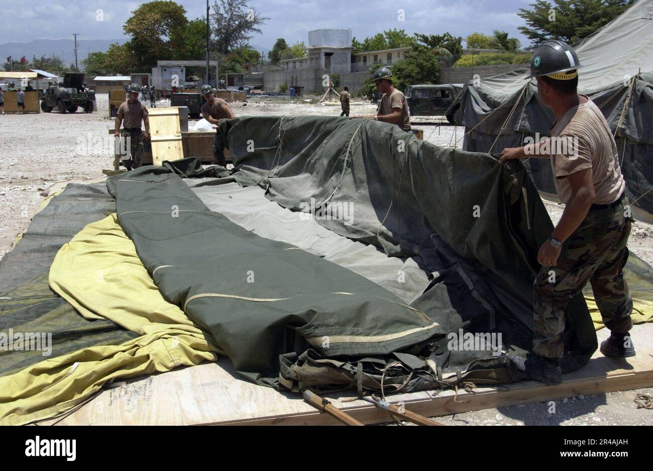 US Navy U.S. Navy Seabees roll a tent up at Camp Unity in preparation ...