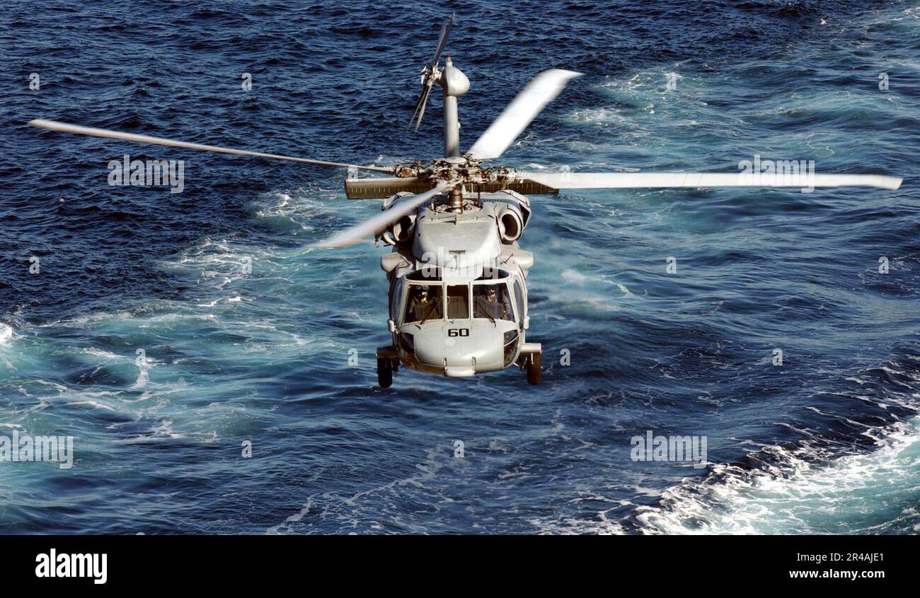 US Navy An MH-60S Knighthawk helicopter prepares to receive and ...
