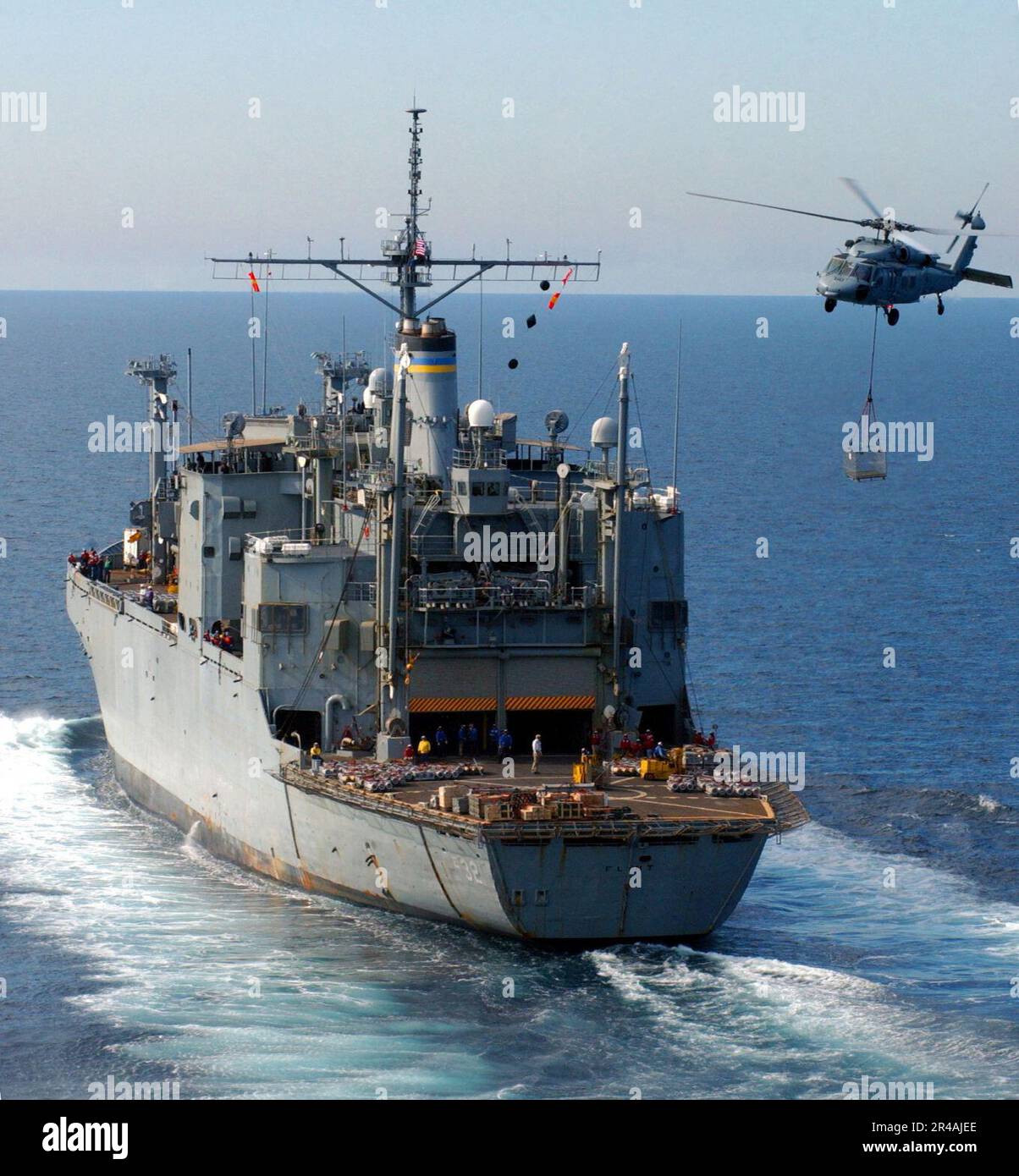 US Navy An MH-60S Knighthawk helicopter transports ordnance from ...