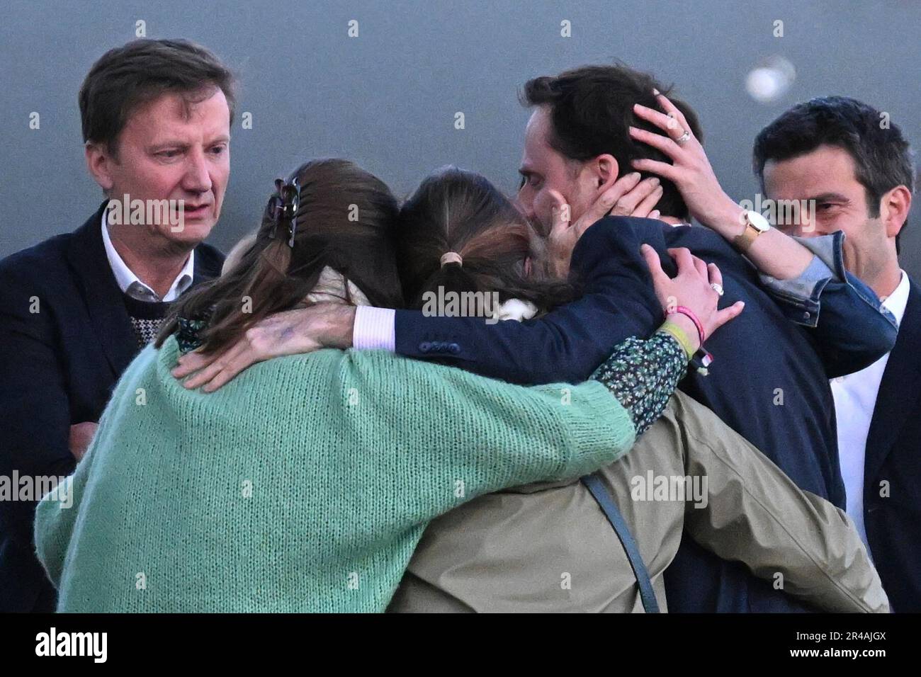 Belgian aid worker Olivier Vandecasteele, second right, is greeted by ...