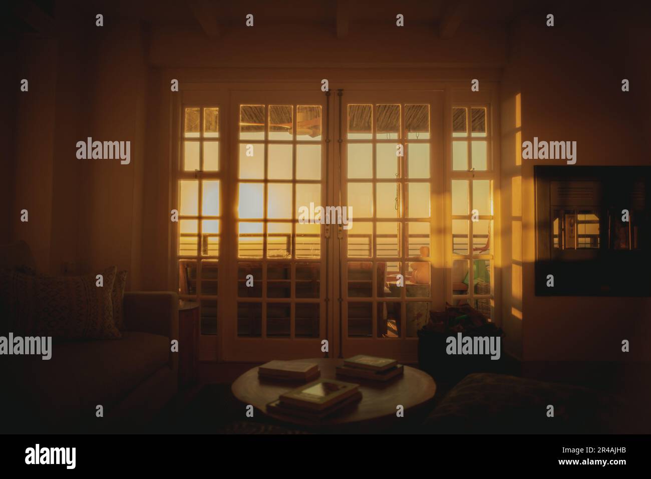 A warm natural light filters through the windows of a modern living ...