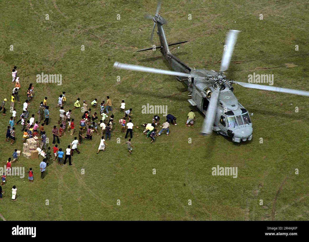 US Navy An SH-60B Seahawk helicopter lands to drop off relief supplies ...
