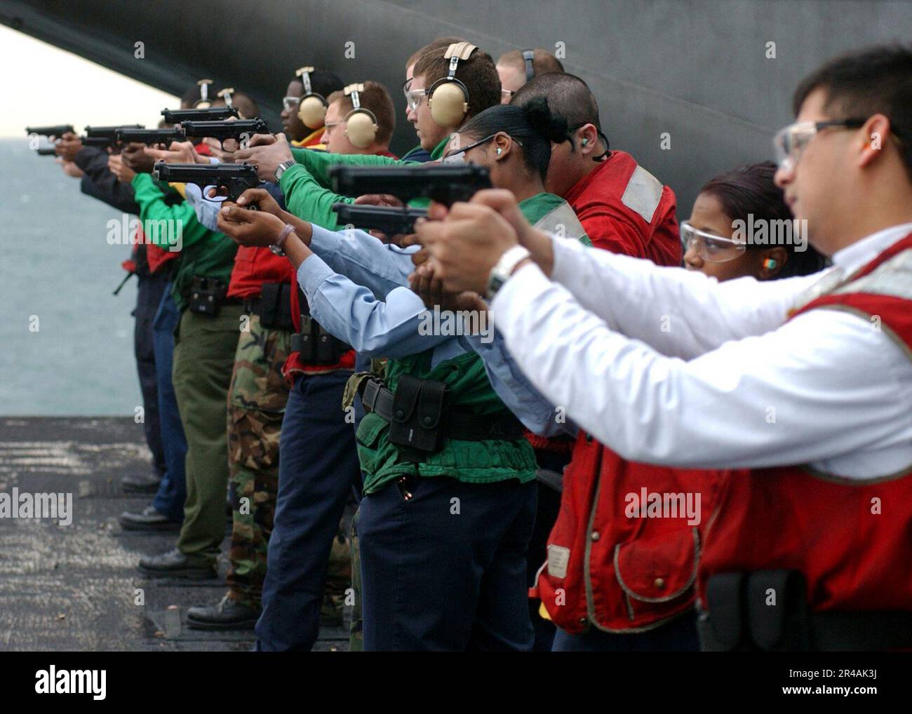 US Navy Sailors take aim at their targets during a small arms ...