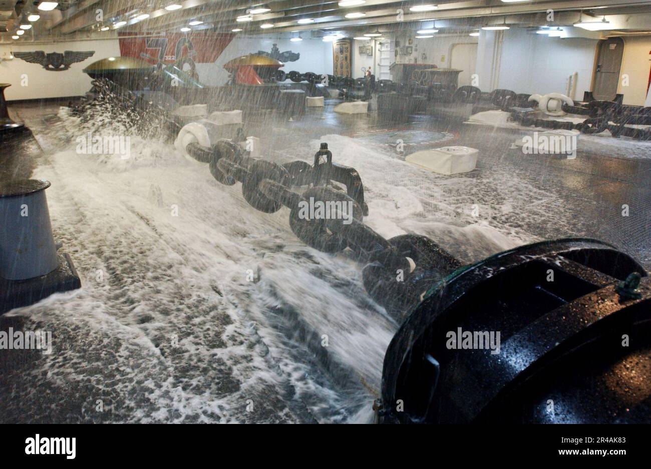 US Navy A strong rush of seawater bursts through the starboard hawse ...