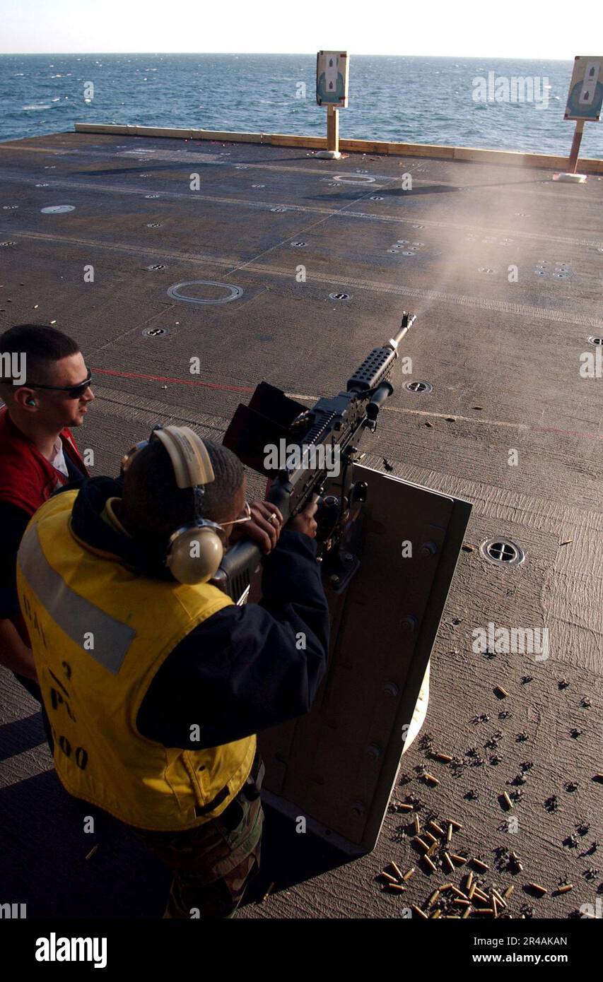 US Navy Gun smoke pours from the barrel of an M-240 machine gun as a ...