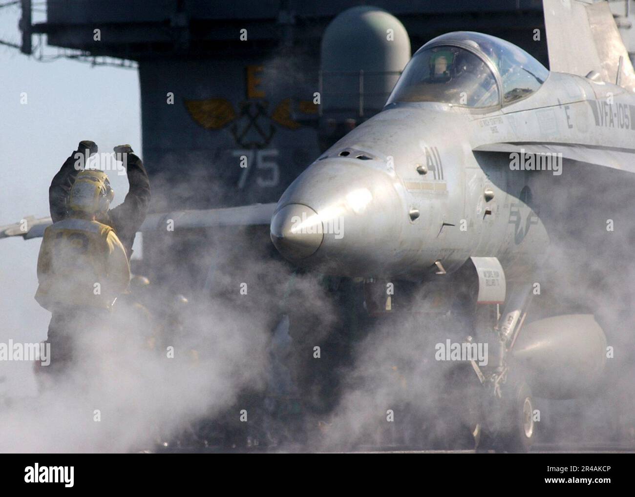 US Navy Flight deck personnel perform final checks on an F-A-18C Hornet ...