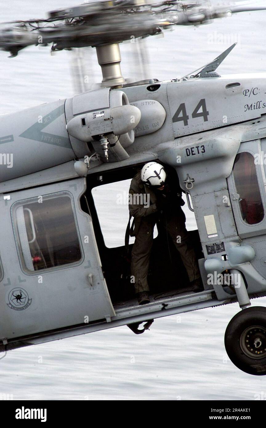 US Navy A member of the flight crew aboard an MH-60S Seahawk, assigned to Helicopter Combat ...