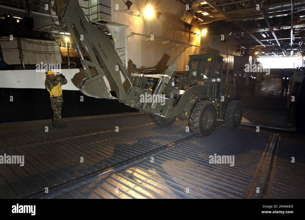 US Navy Sailor directs equipment from the Landing Craft Utility (LCU ...