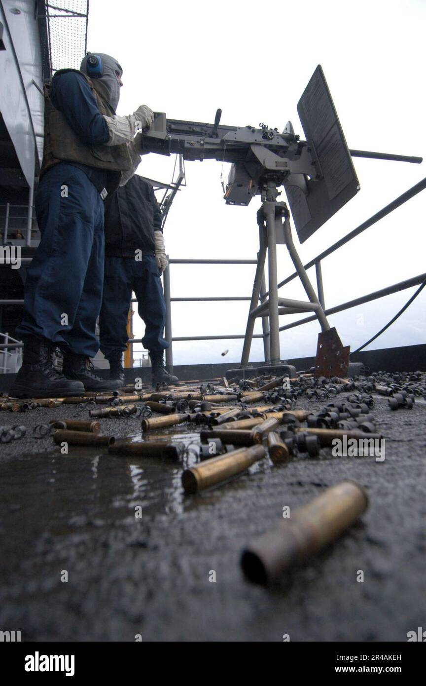 US Navy Weapons department personnel fire a Browning .50-caliber ...