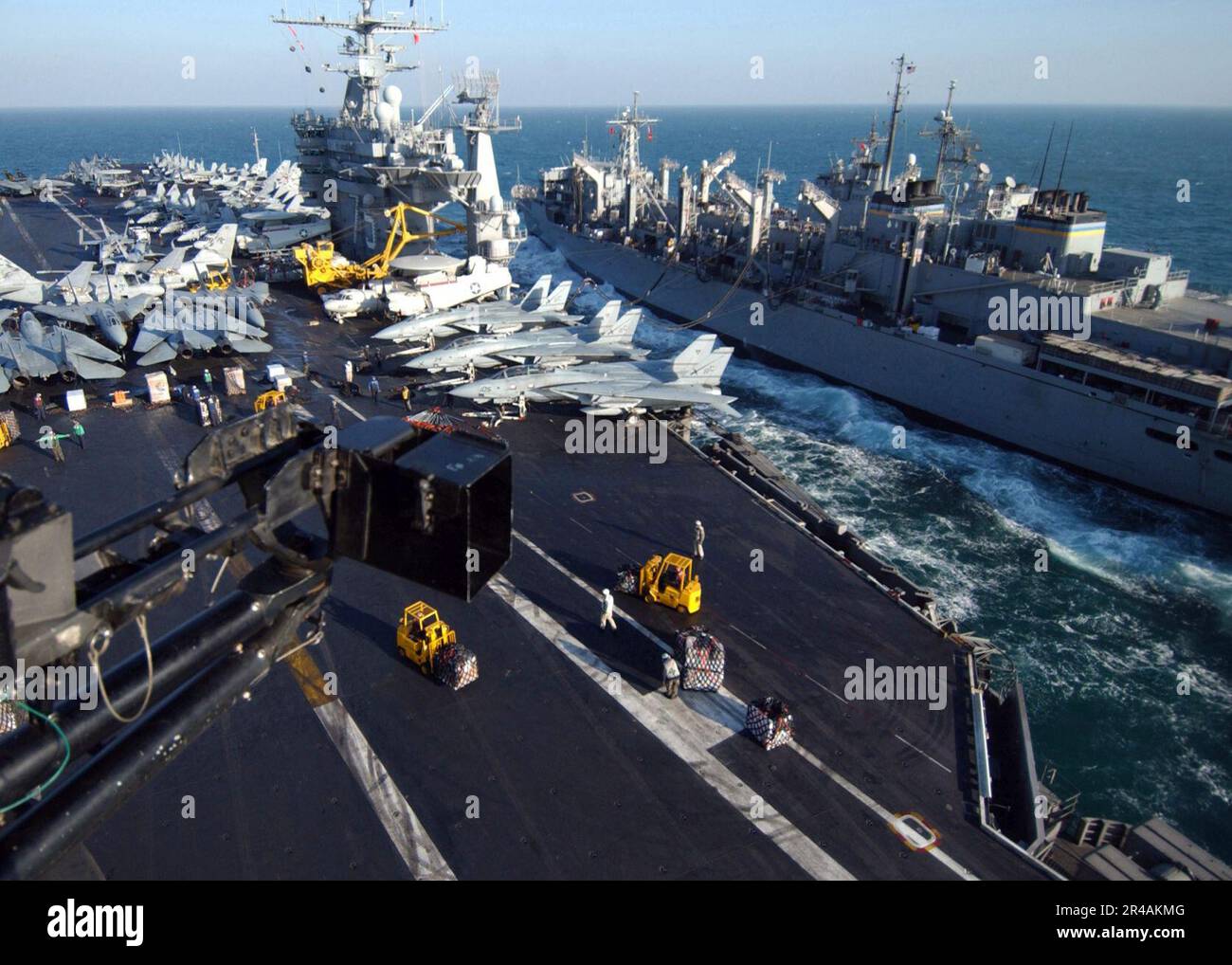 US Navy Flight deck personnel move supplies and stores on the flight ...