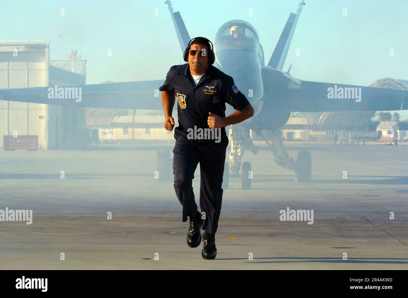 US Navy Crew Chief Aviation Ordnanceman 1st Class moves to a safe ...