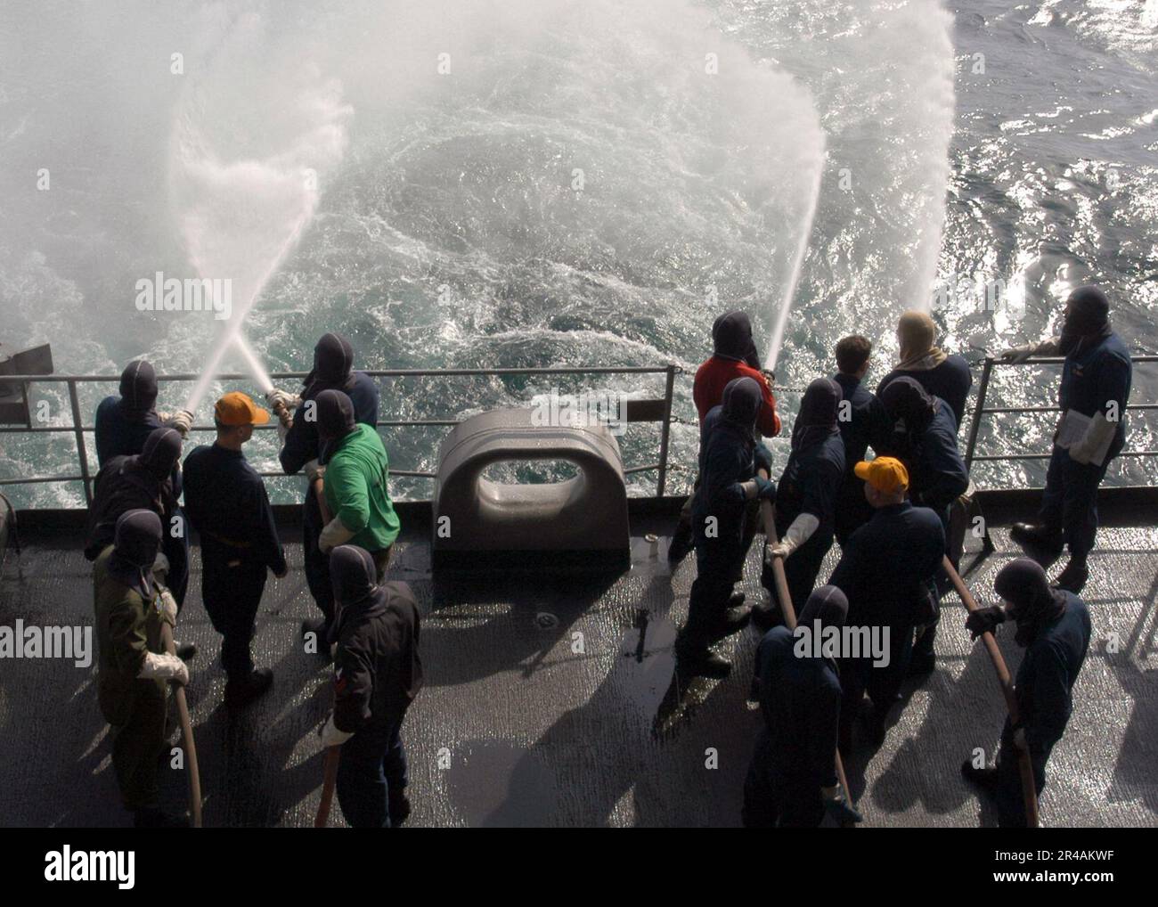 US Navy Sailors, assigned to Repair Locker 1A, perform fire hose ...