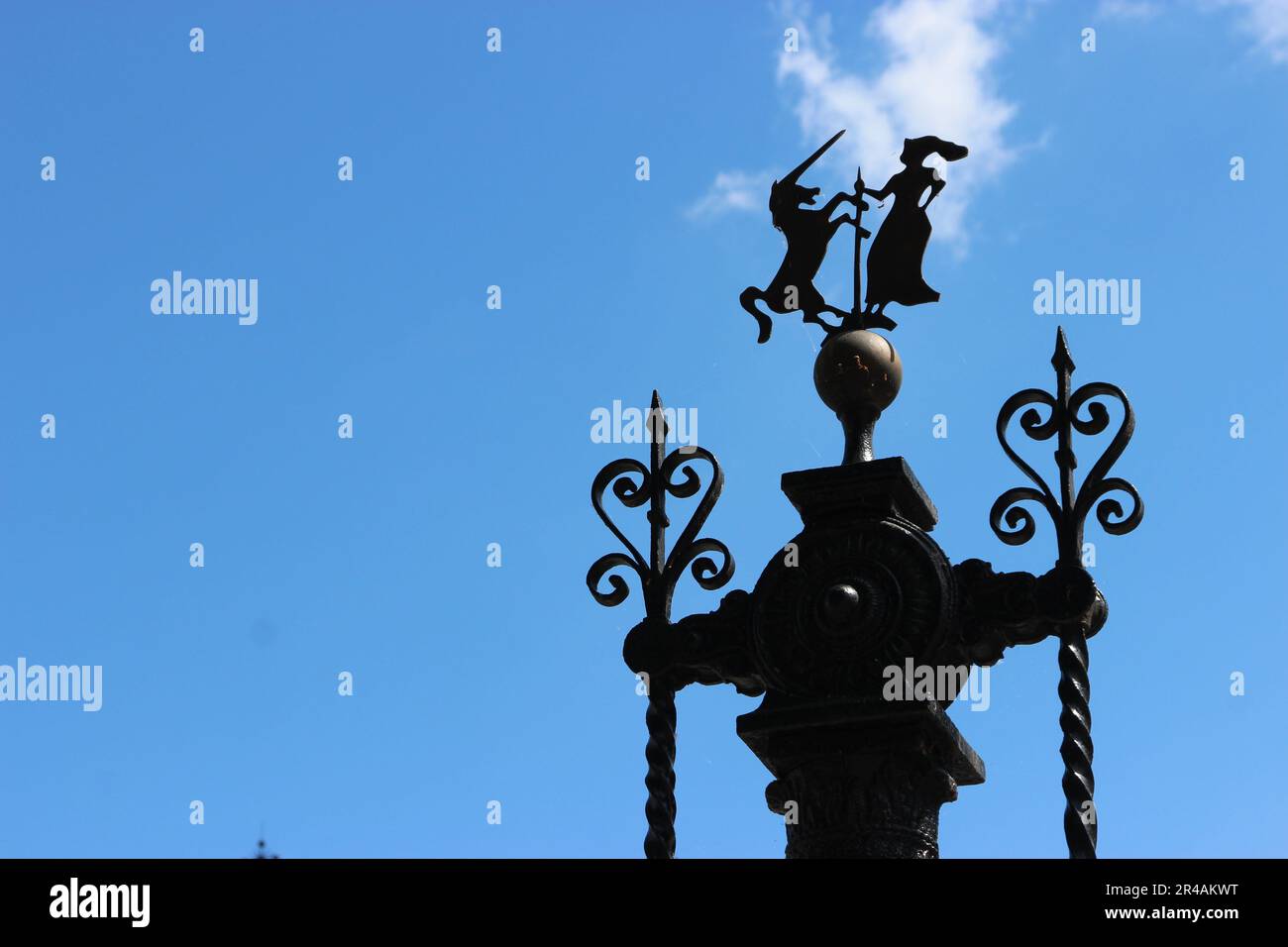 An impressive large metal statue stands tall with a decorative top ...