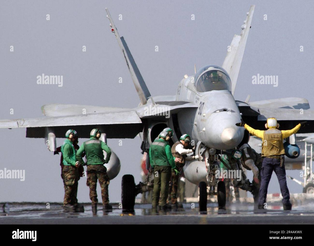 US Navy Air Department and squadron personnel make final checks on an F ...