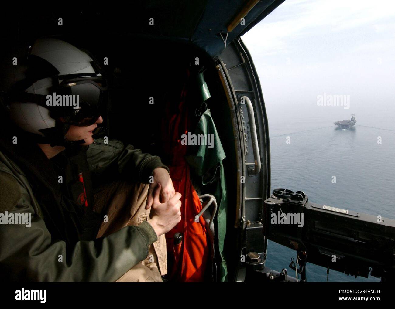US Navy An Aviation Warfare Systems Operator watches from his door ...