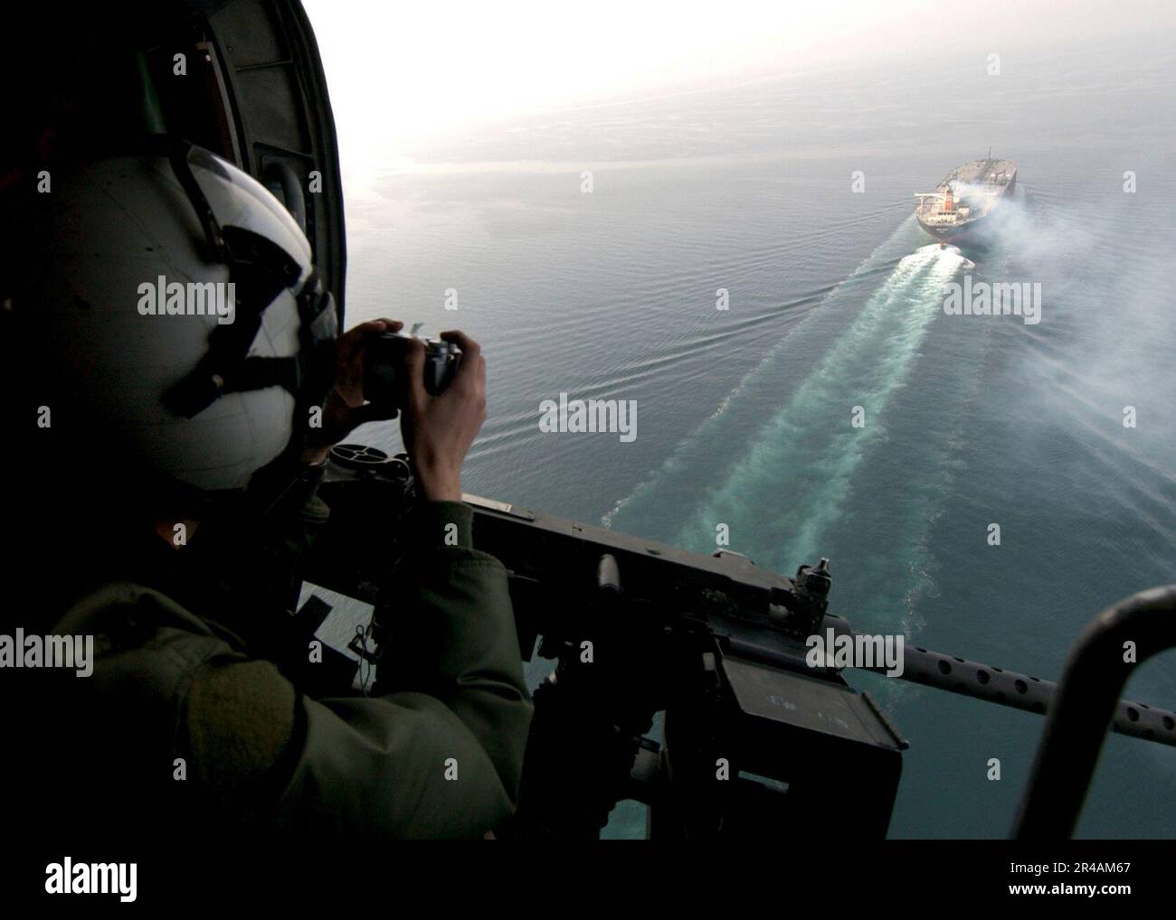 US Navy An Aviation Warfare Systems Operator takes a photograph of an ...
