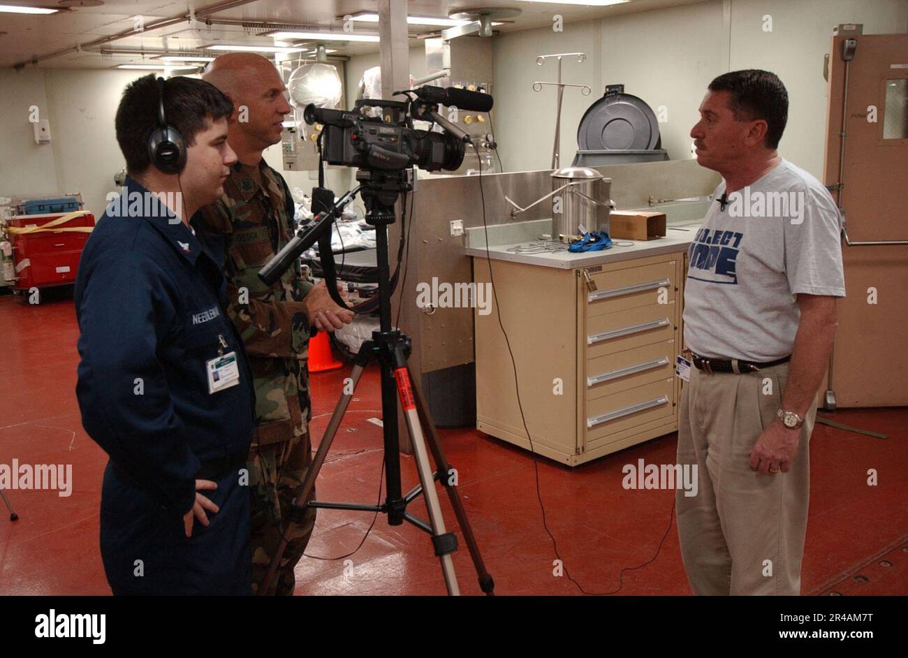 US Navy Journalist 3rd Class foreground, and Photographer's Mate 1st ...