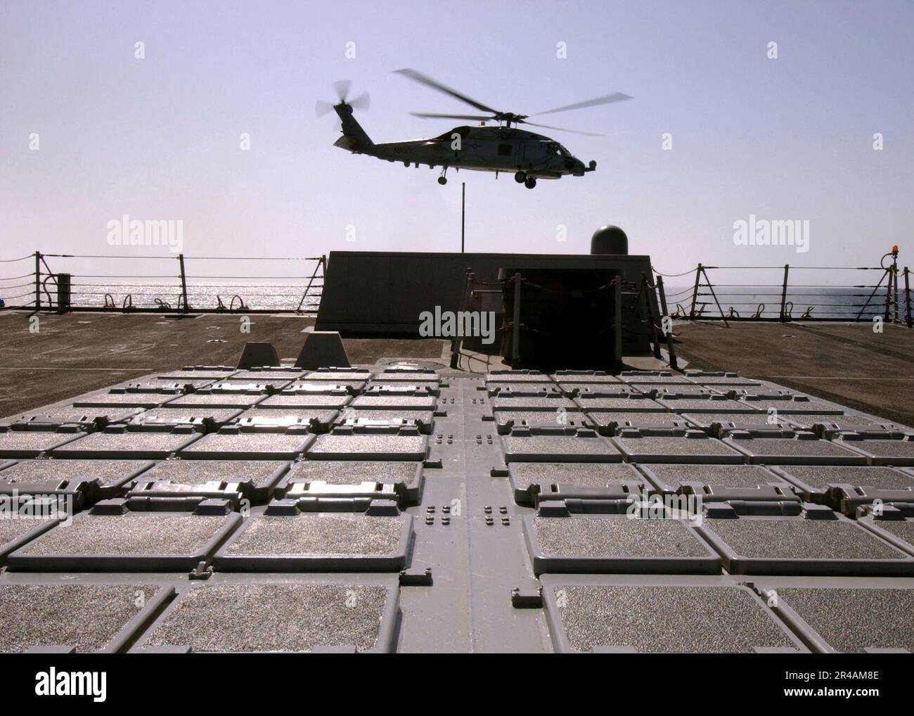 US Navy An SH-60B Seahawk flies past the fantail of the guided missile ...