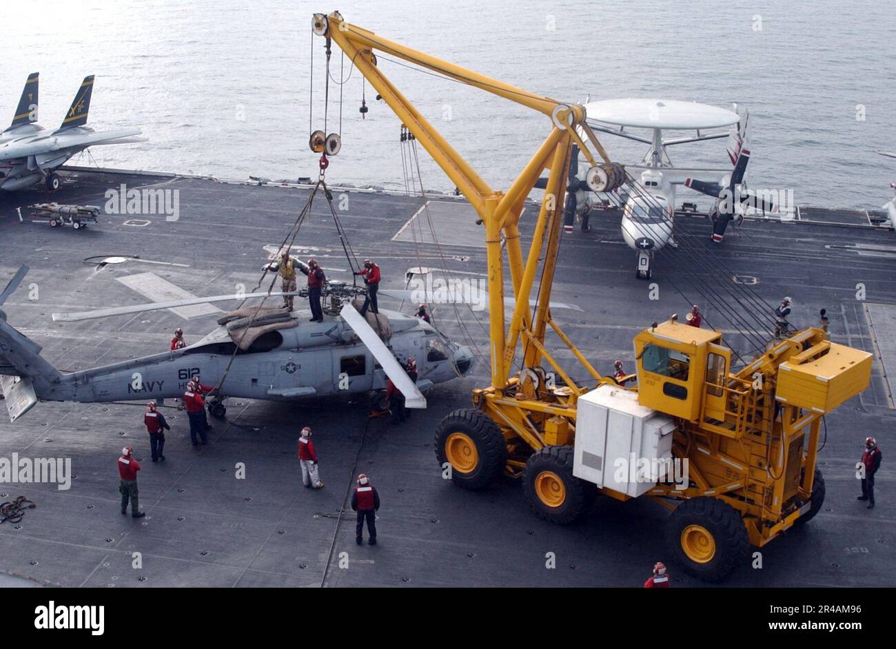 US Navy Flight deck personnel aboard the Nimitz-class aircraft carrier ...