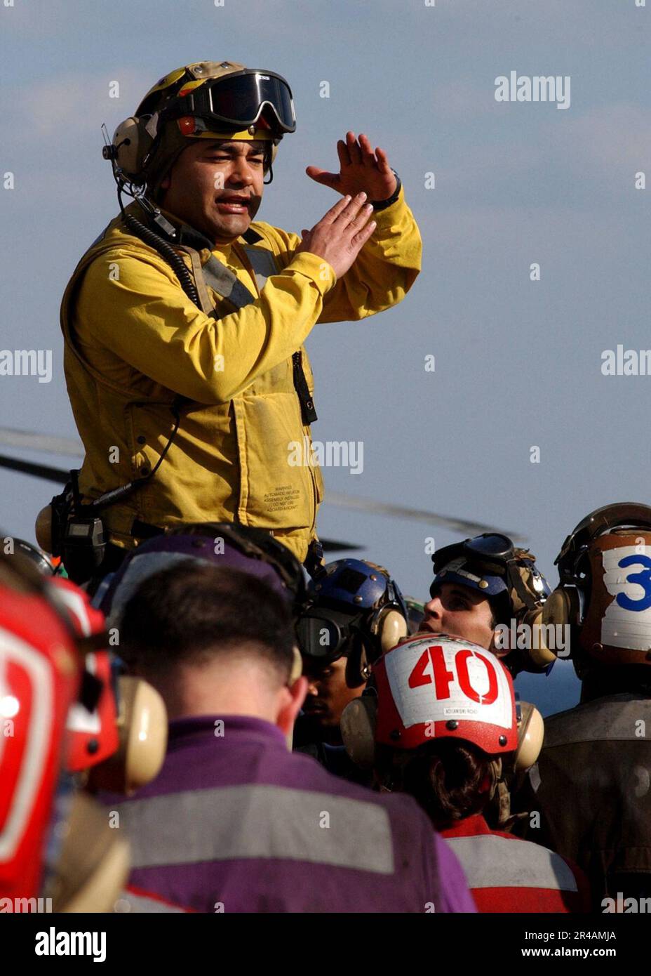 US Navy Flight Deck Officer Ens. Oscar Flores briefs flight deck ...