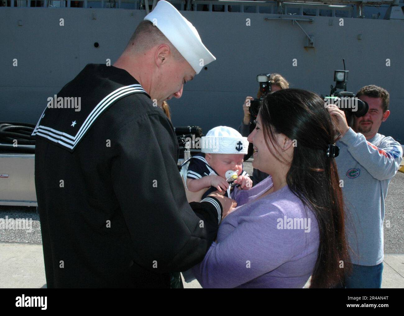 US Navy Fire Controlman 1st Class embraces his new son with wife for ...