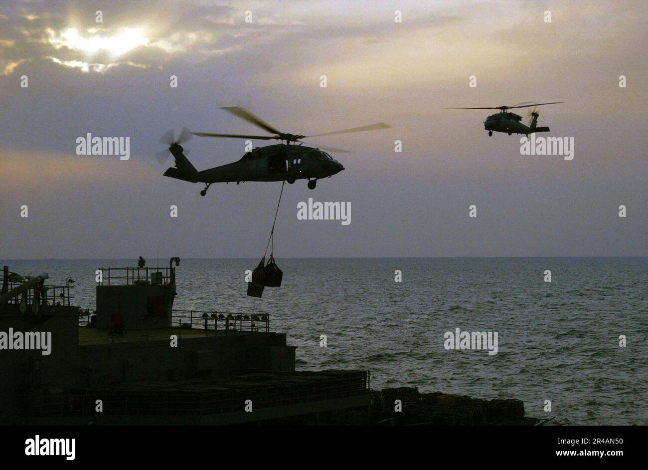 US Navy MH-60S Seahawks transport supplies during a vertical ...
