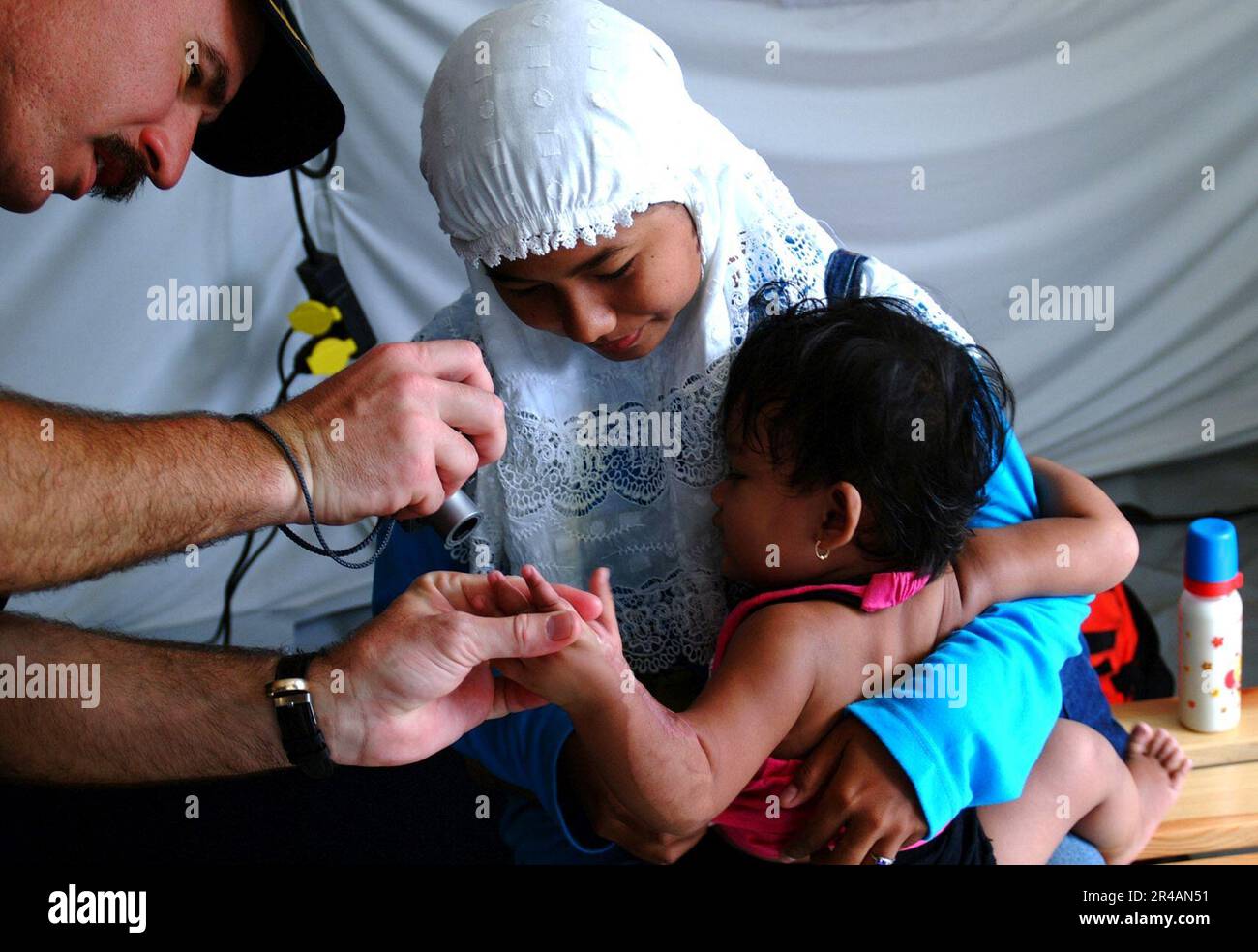 US Navy Cmdr. Kurt Hummeldorf of the U.S. Navy Dental Corps, assesses ...
