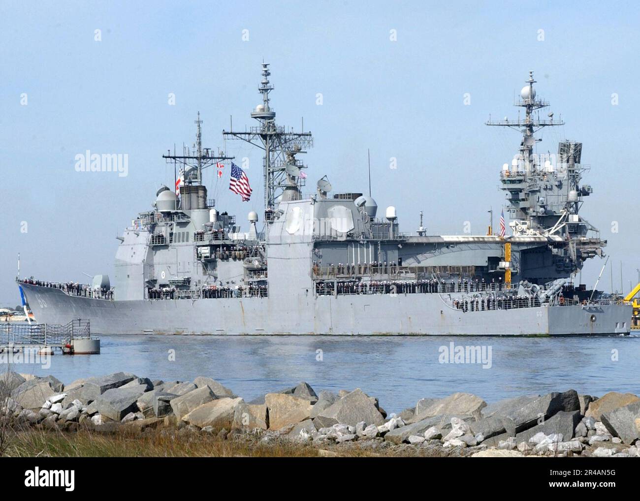 US Navy Sailors man the rails of the guided missile cruiser USS Hue ...