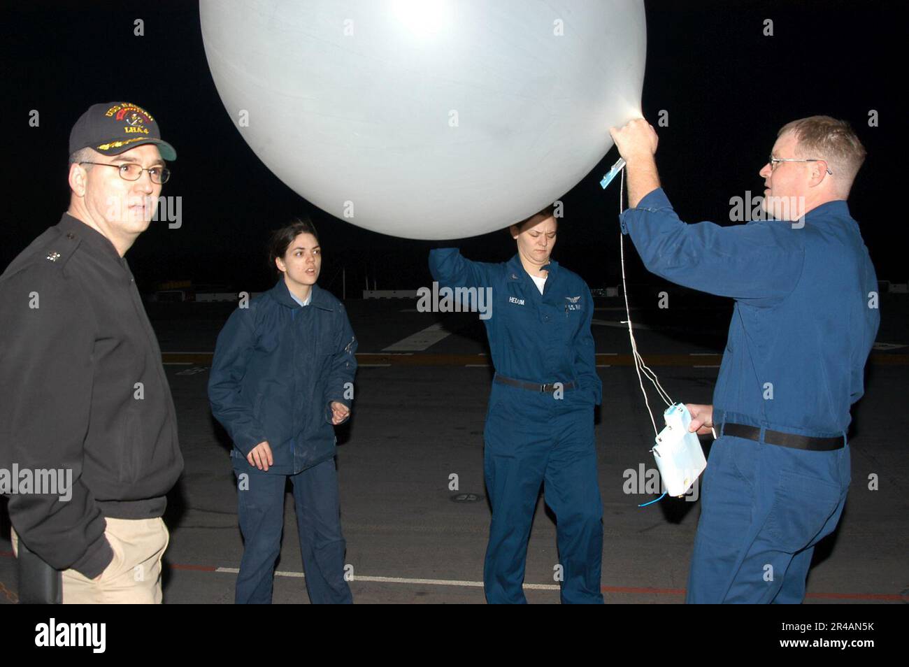 US Navy Aerographer's Mates release a weather balloon from the flight ...
