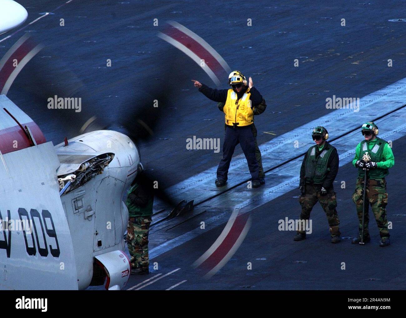 US Navy Sailors position an E-2C Hawkeye, assigned to the Seahawks of ...