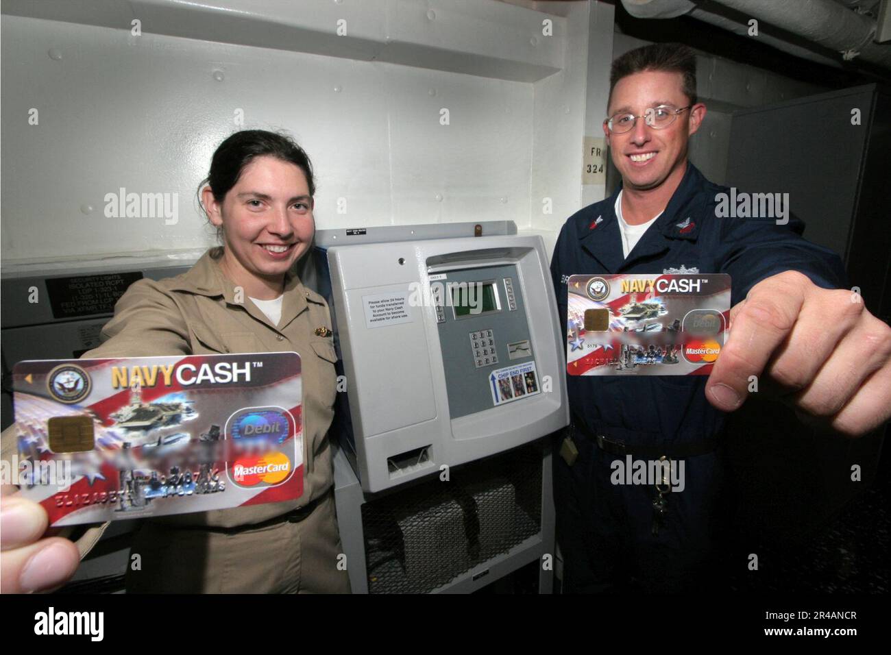 US Navy Disbursing Officer, Lt.j.g. left, and Disbursing Clerk 1st Class display their Navy Cash ...