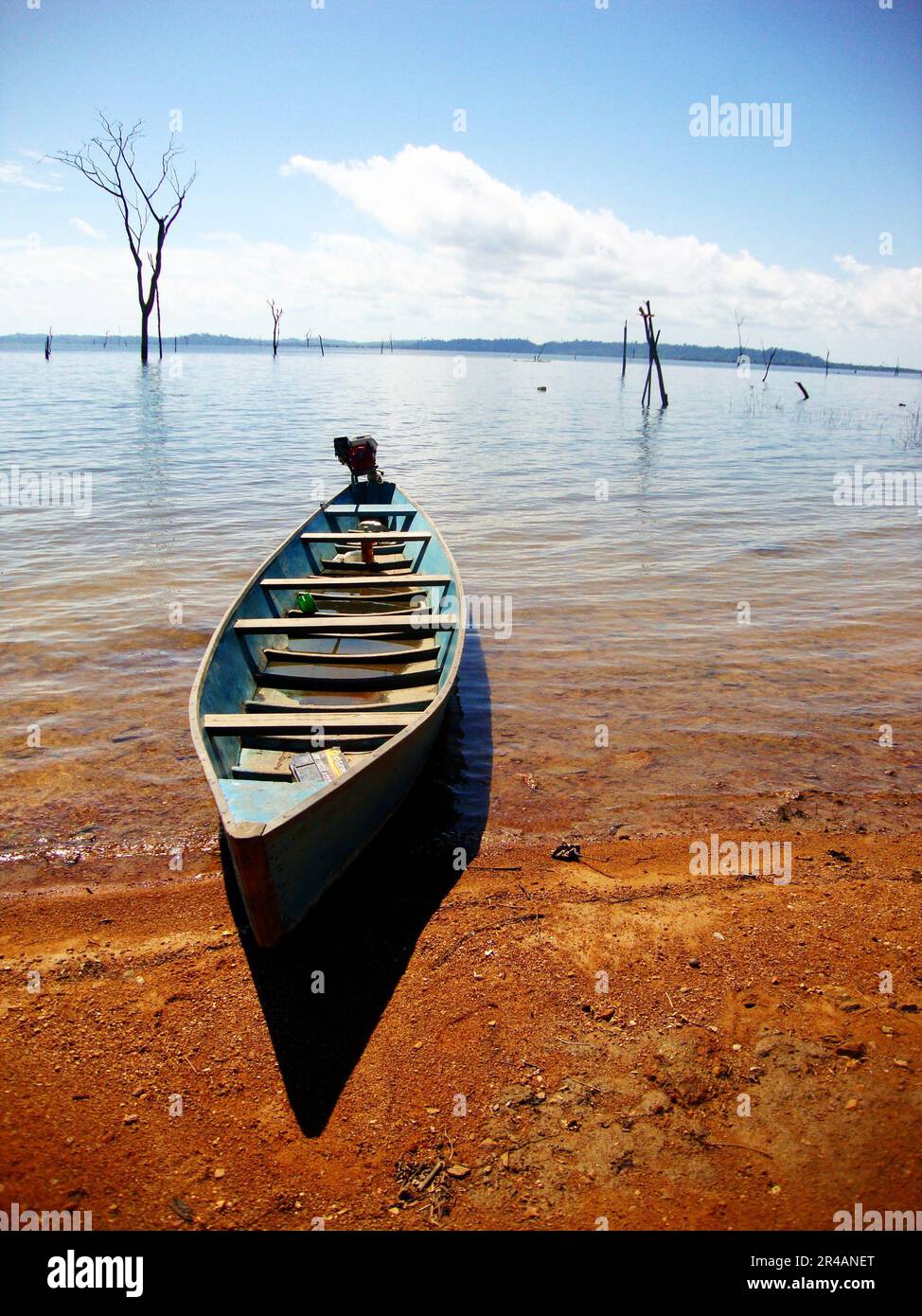 A stranded canoe rests on the shore, bearing witness to the ecological ...