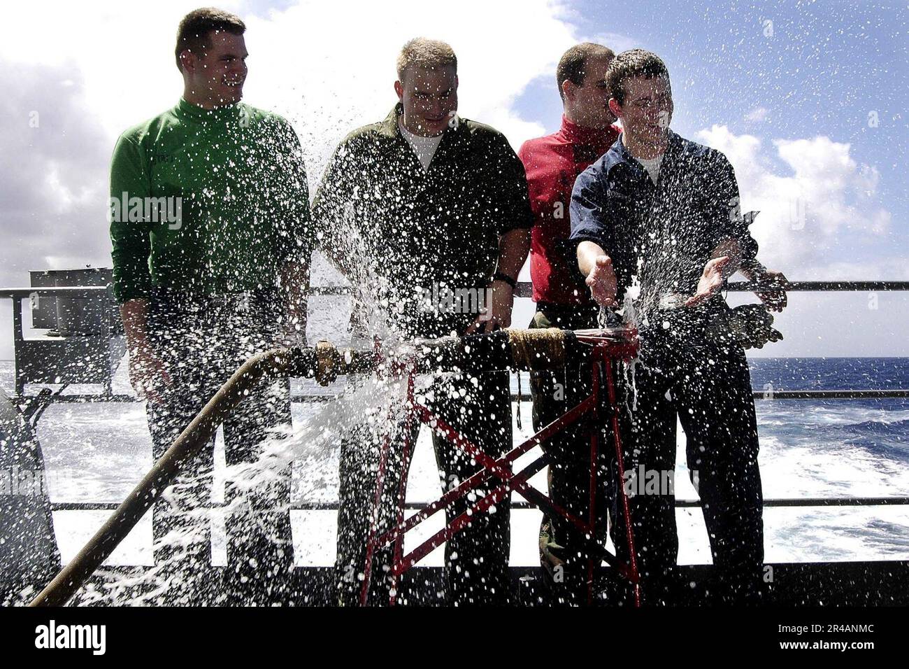 US Navy Water sprays from a pipe after Sailors apply a soft patch to a ...