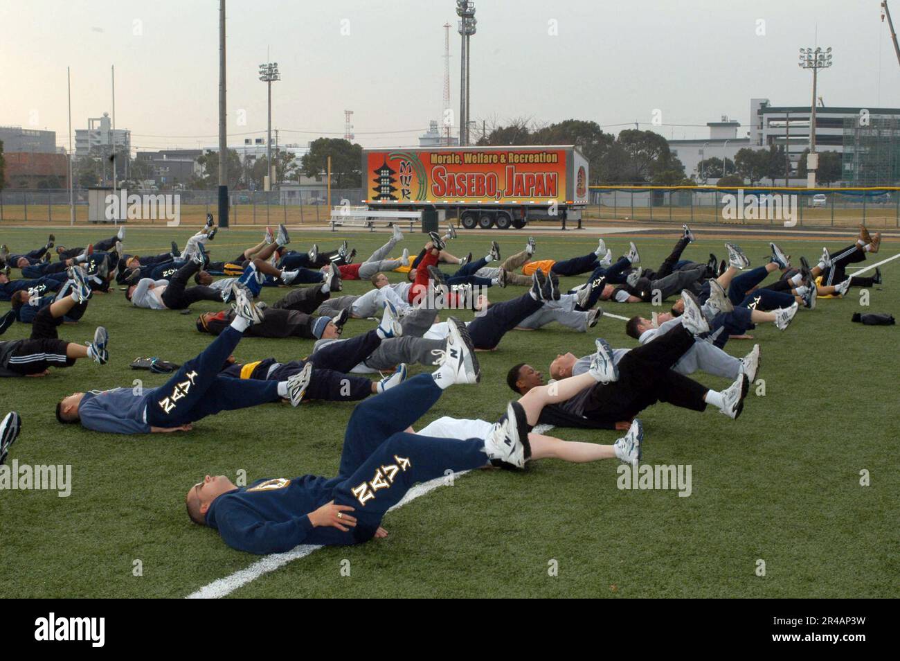 US Navy Sailors perform flutter kicks during physical training held at ...