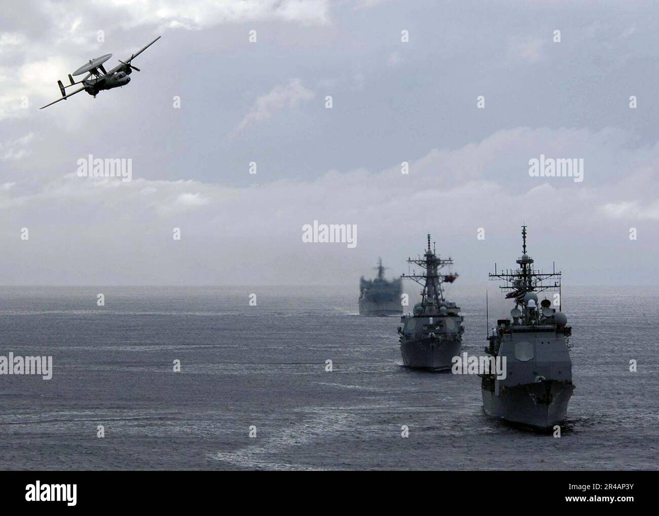 US Navy An E-2C Hawkeye conducts a flyby in front of the ships ...