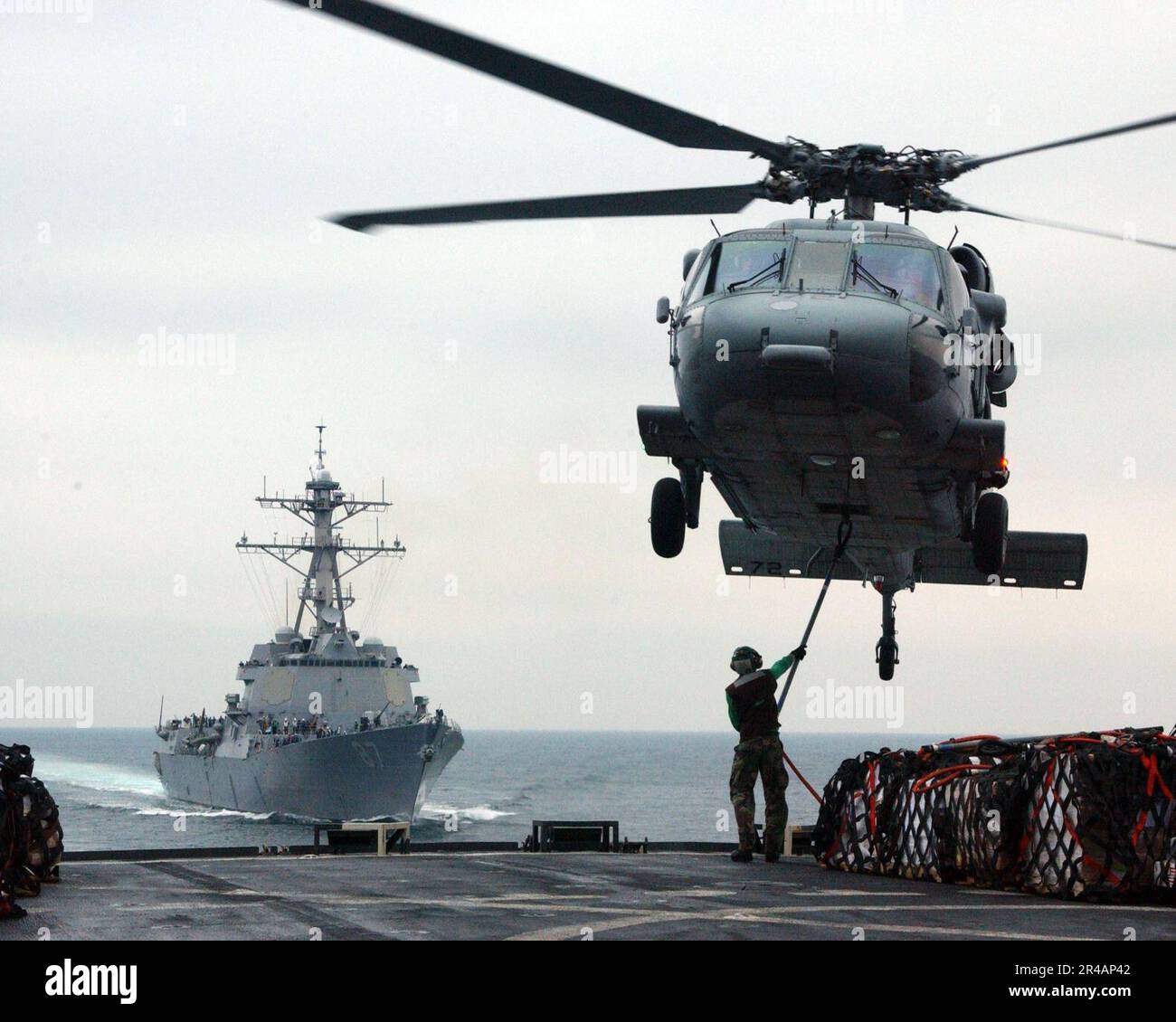 US Navy A cargo handler attaches a cargo pendant onto an MH-60S Seahawk ...