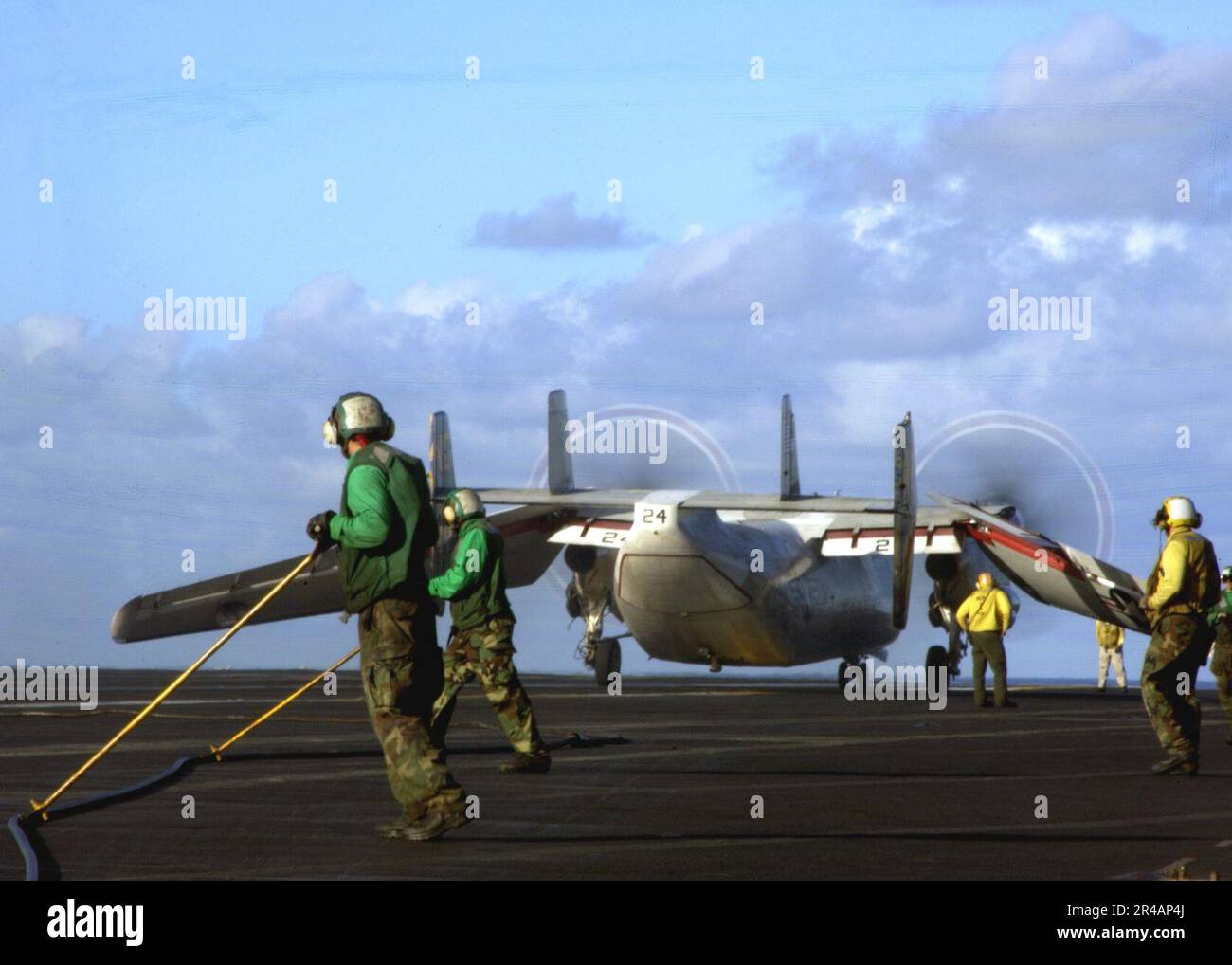 US Navy Air Department personnel guide an arresting cable after the ...