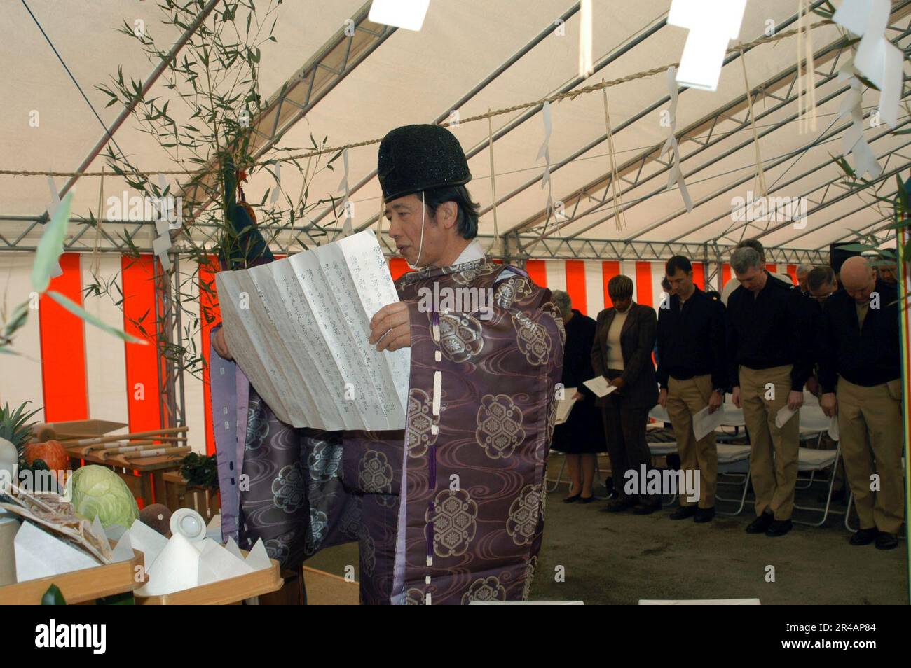 US Navy Attendees bows their heads as a Shinto Priest reads a prayer ...