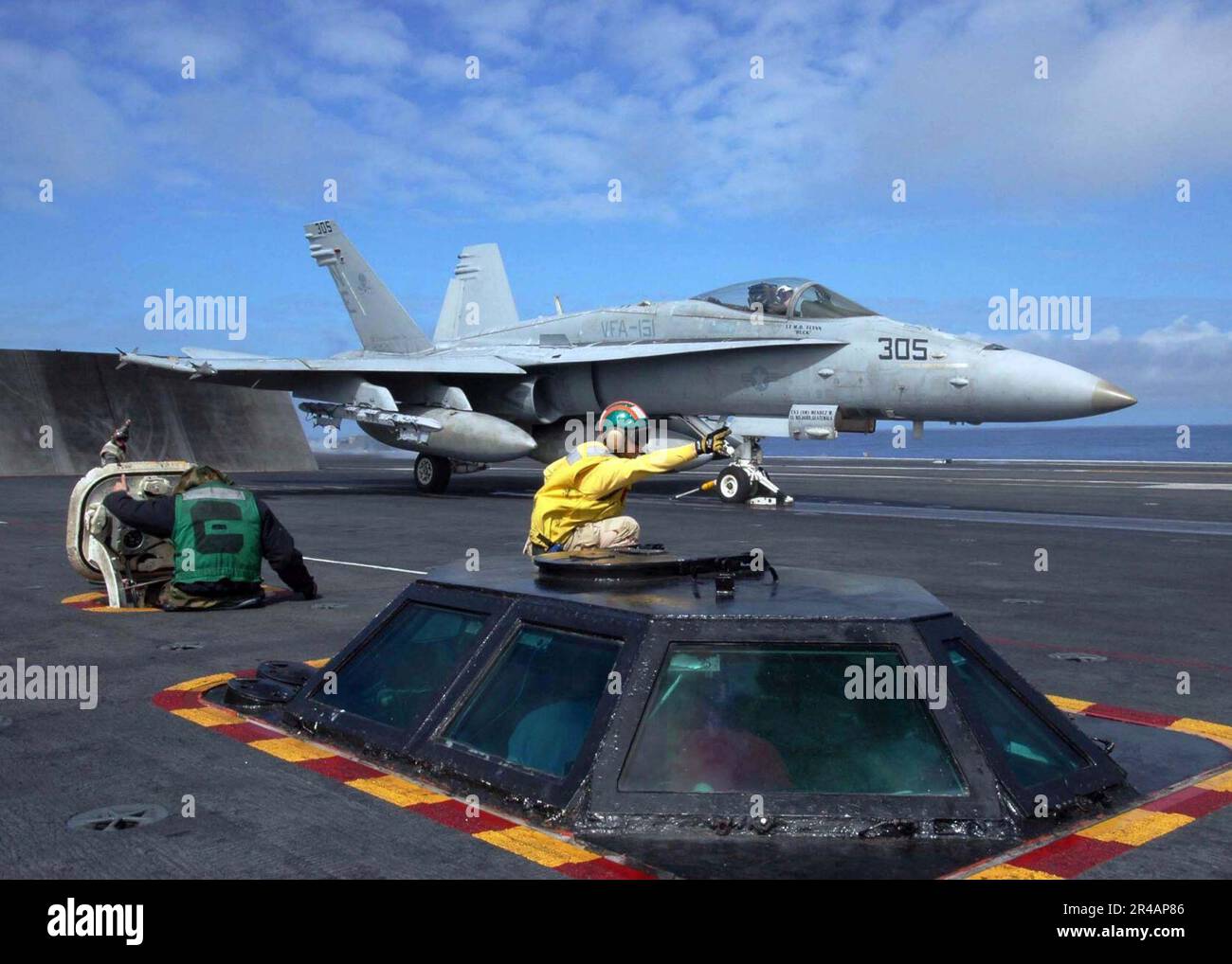US Navy A catapult shooter signals for the launch of an F-A-18C Hornet ...