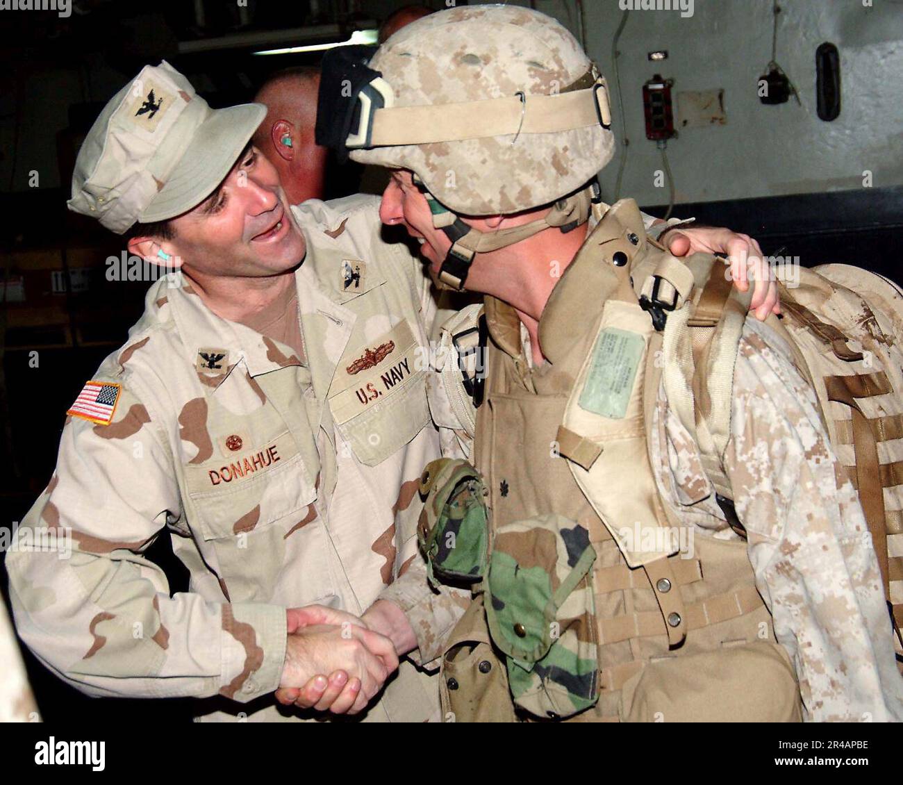 US Navy Commodore Mark Donahue, left, greets Stock Photo - Alamy