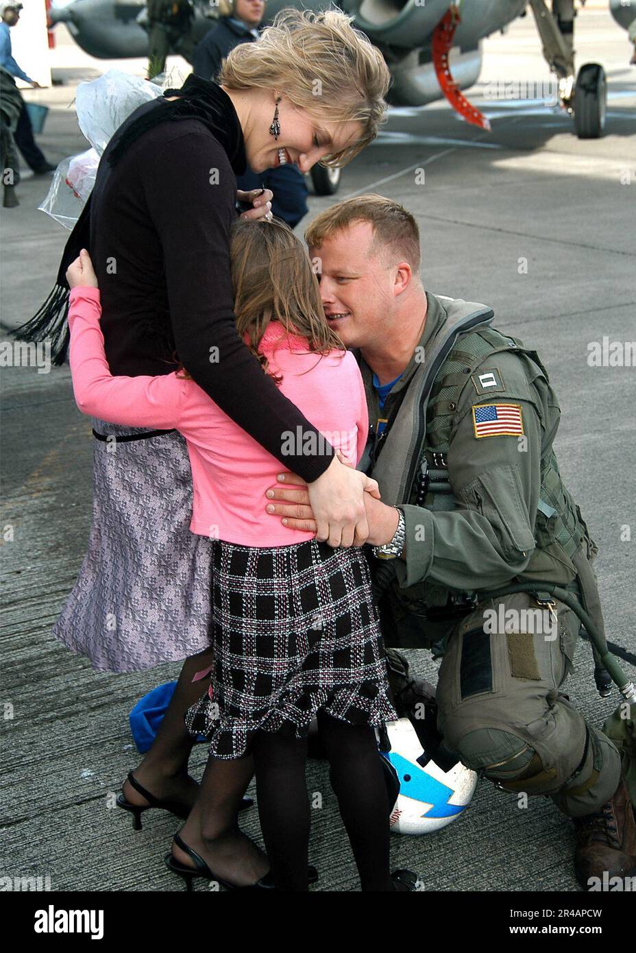 US Navy An air crew member greets his loved ones after returning from a ...