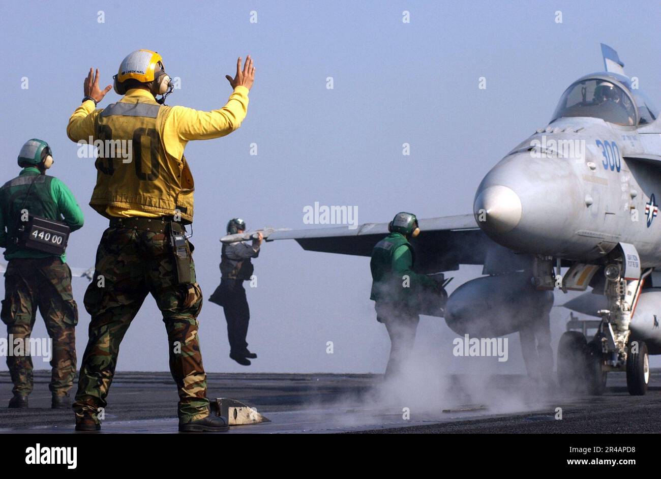 US Navy An Aviation Boatswain's Mate prepares to guide an F-A-18C ...