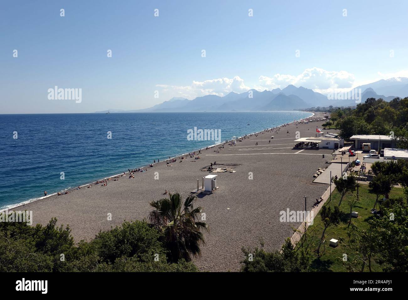 Sun, endless beach, cloudless sky, sea and far mountains in Antalya ...