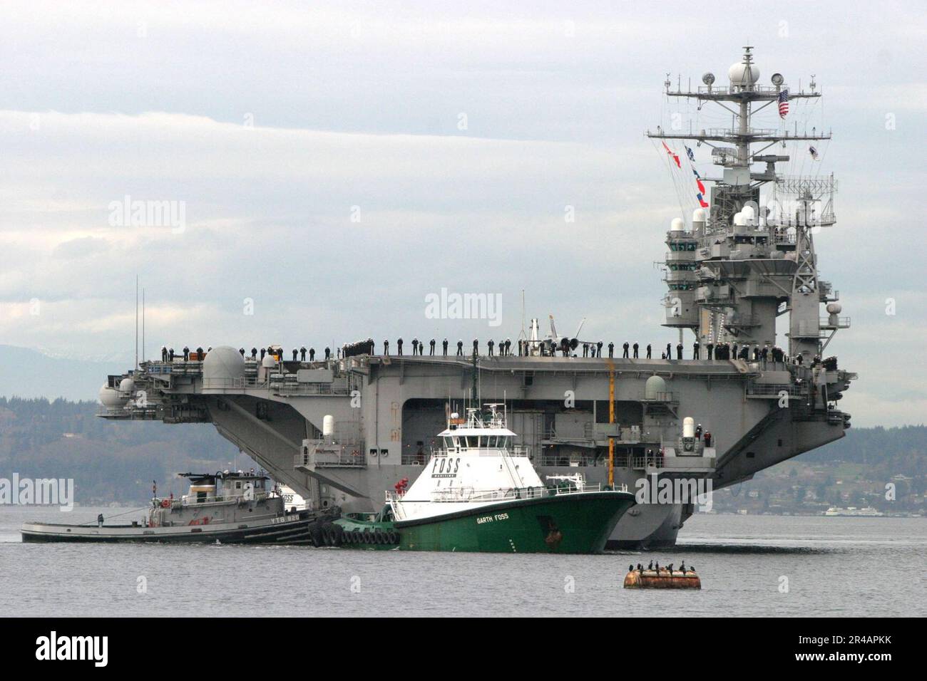 US Navy The crew of the Nimitz-class aircraft carrier USS Abraham ...
