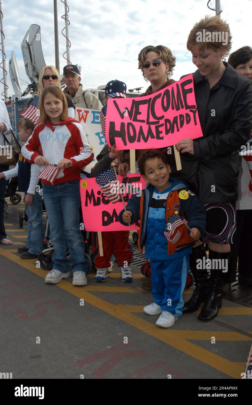 US Navy Hundreds of friends and family gather at the pier on board ...