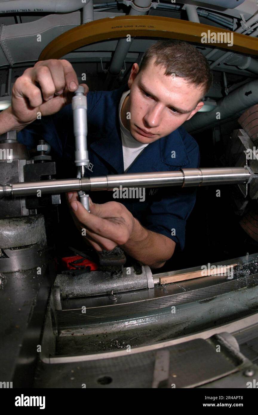 US Navy Machinery Repairman Fireman constructs a pump shaft aboard the ...