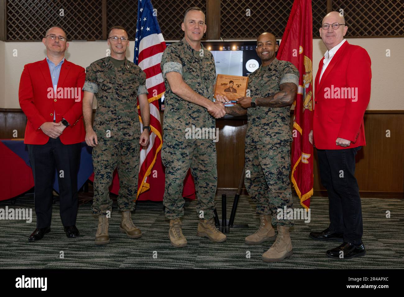 U.S. Marine Corps Master Gunnery Sgt. Fred Foster accepts a plaque on behalf of Master Gunnery ...