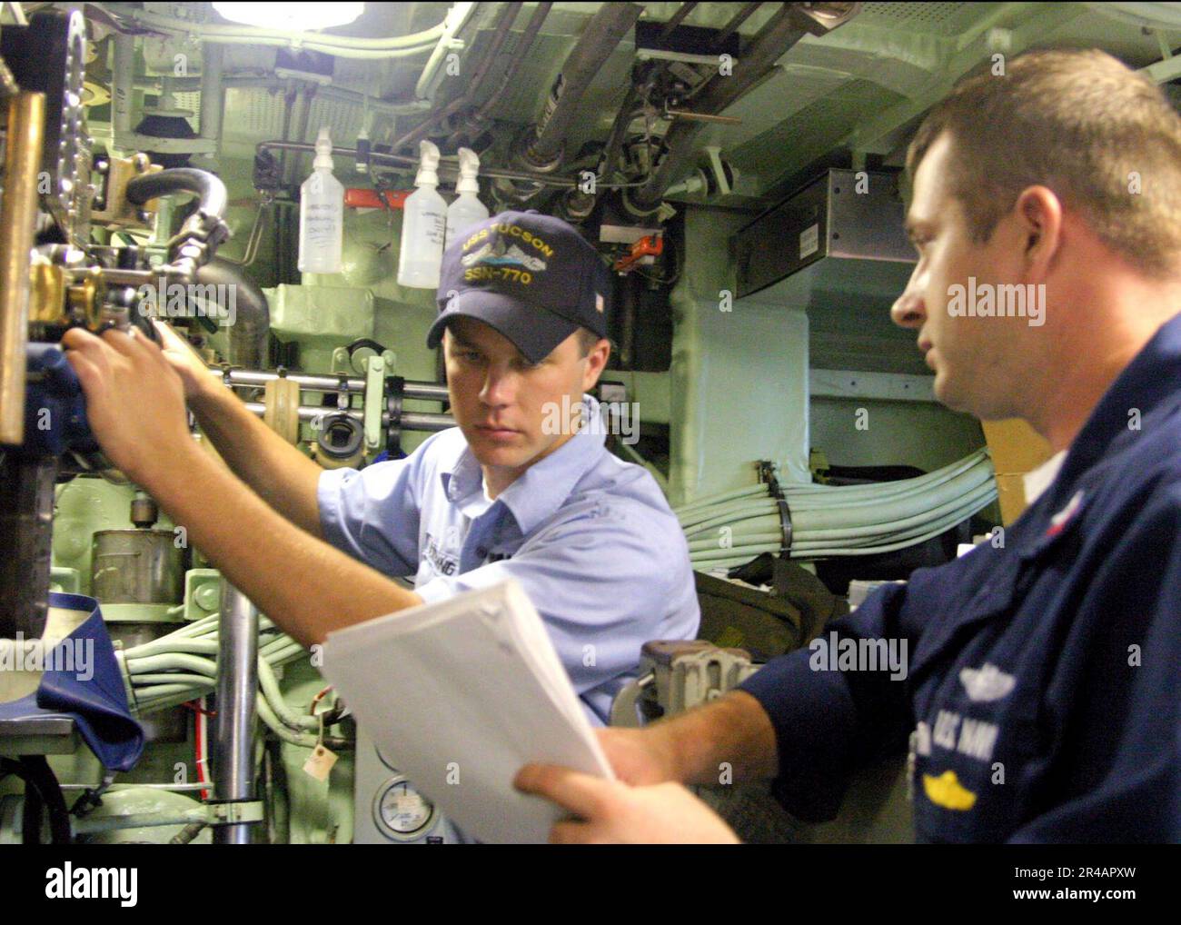 US Navy Machinist Mate 2nd Class left, assigned to the Los Angeles ...