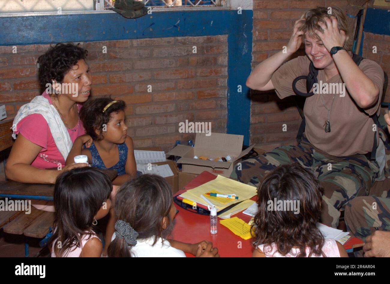 US Navy U.S. Navy Lt. Cmdr. shows a group of young children how to wash ...