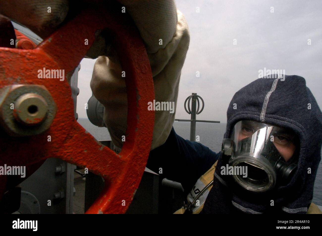 US Navy A fire team plug man opens a fire main on the signal bridge ...